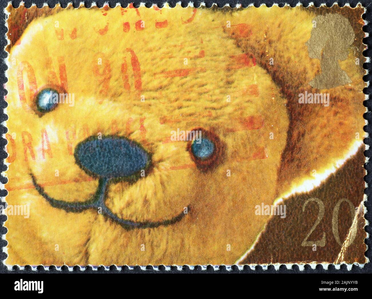 Smiling teddy bear on british postage stamp Stock Photo - Alamy