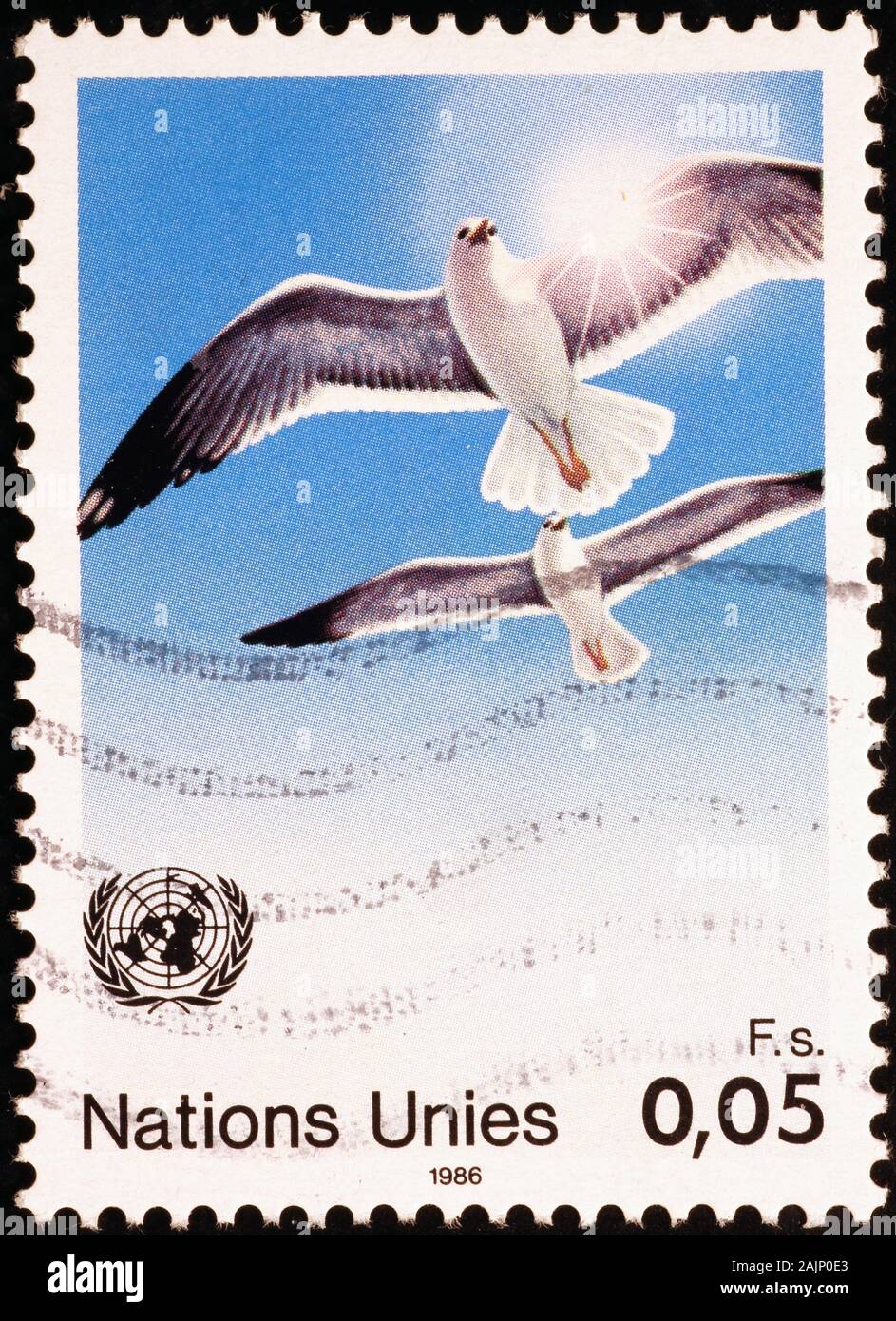 Gulls flying in backlit on postage stamp Stock Photo - Alamy