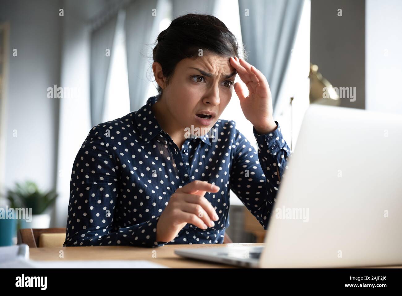 Shocked young indian girl look at laptop screen feel terrified Stock ...