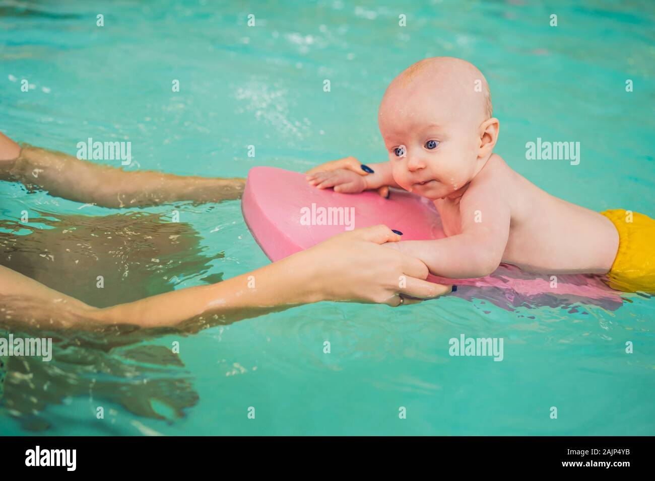 Little baby learning to swim underwater in a swimming pool hi-res stock ...