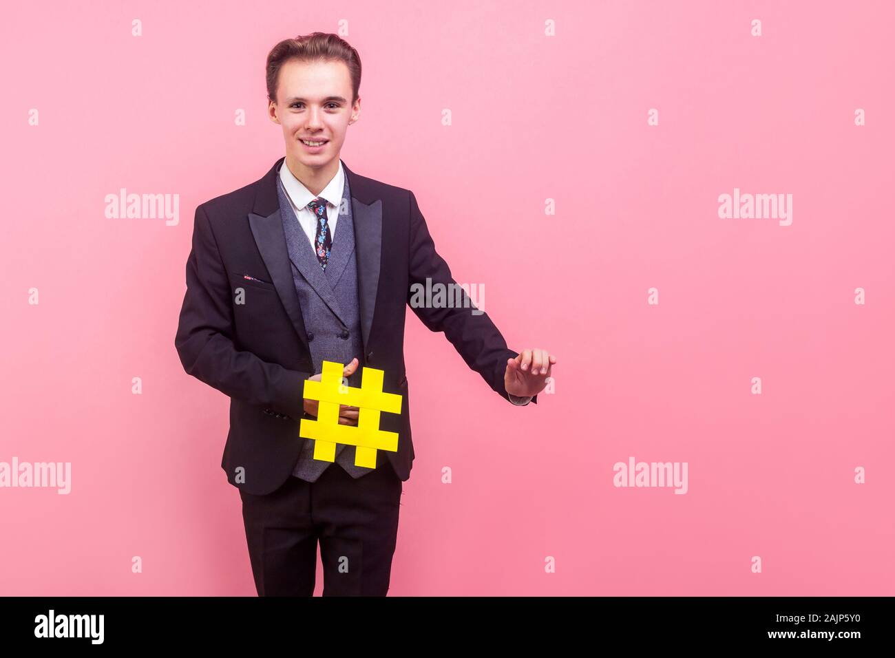 Portrait of elegant happy man in suit with stylish haircut holding ...