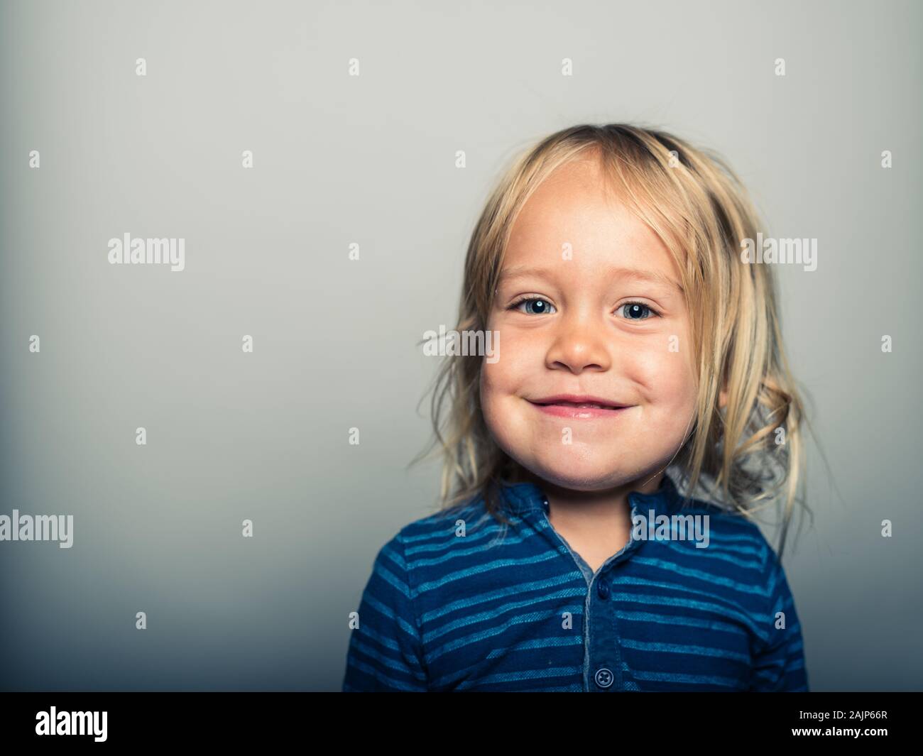 Studio portrait of a toddler doing smiling faces Stock Photo - Alamy