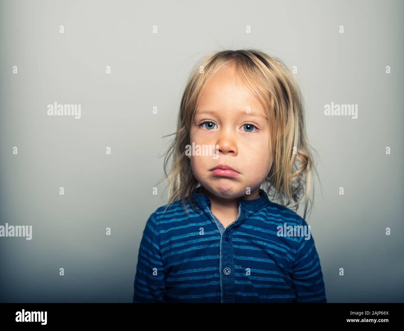 Studio portrait of a toddler doing sad faces Stock Photo - Alamy