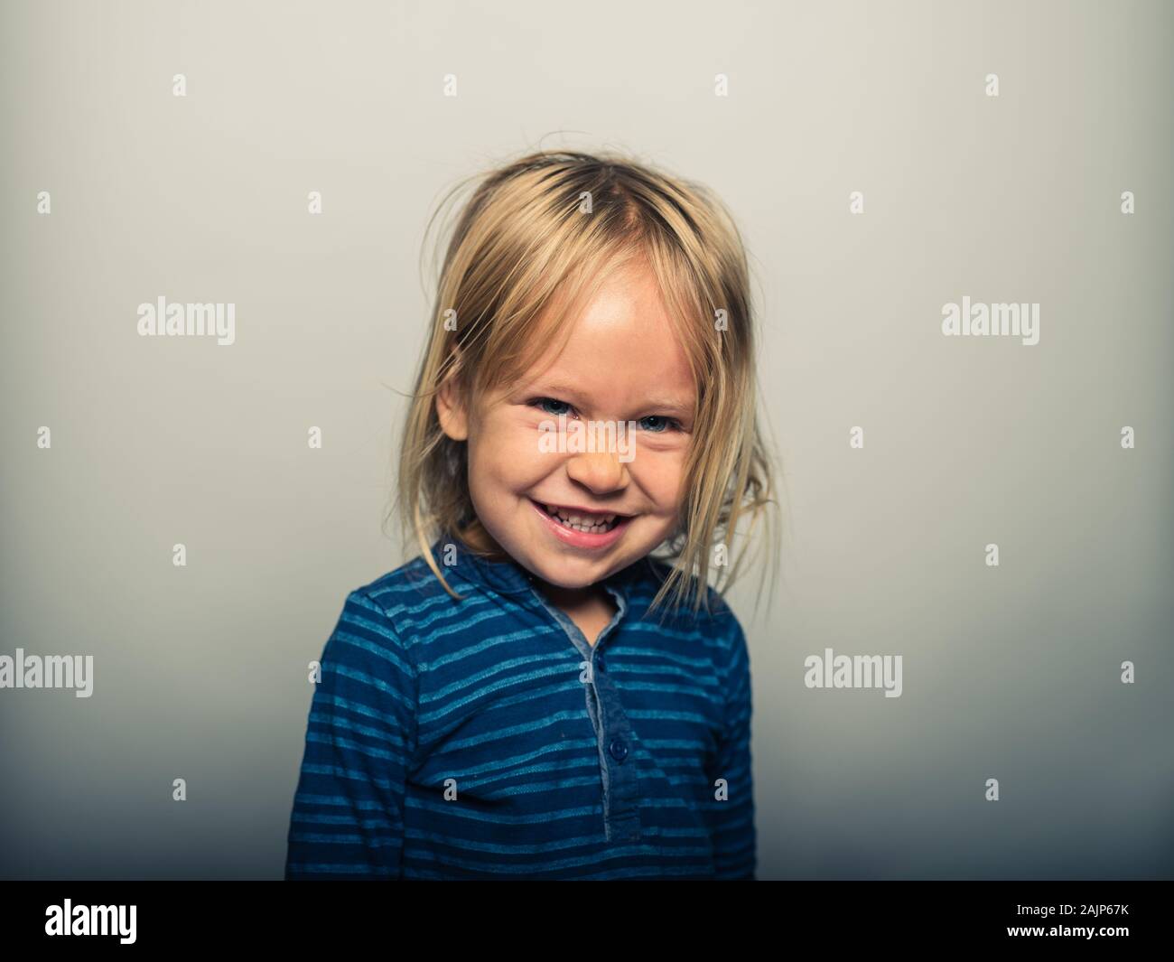 Studio portrait of toddler pulling faces Stock Photo - Alamy
