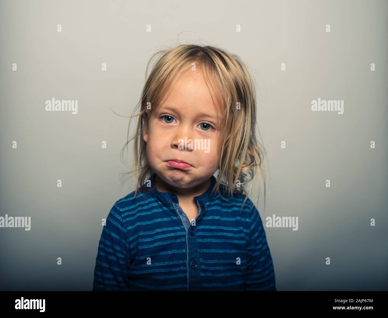 Studio portrait of toddler pulling faces Stock Photo - Alamy