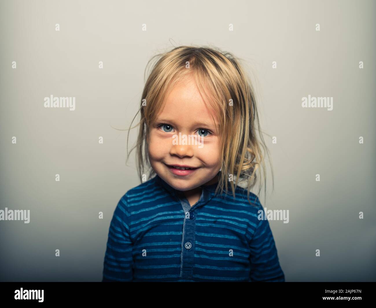 Studio portrait of a toddler doing smiling faces Stock Photo - Alamy