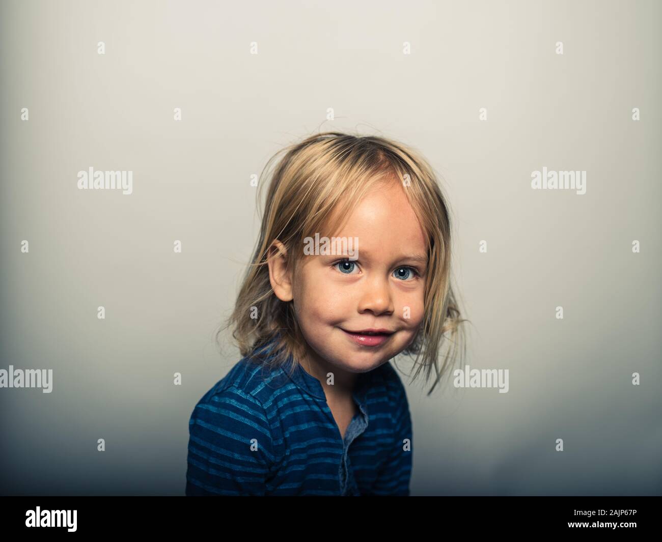 Studio portrait of toddler pulling faces Stock Photo - Alamy