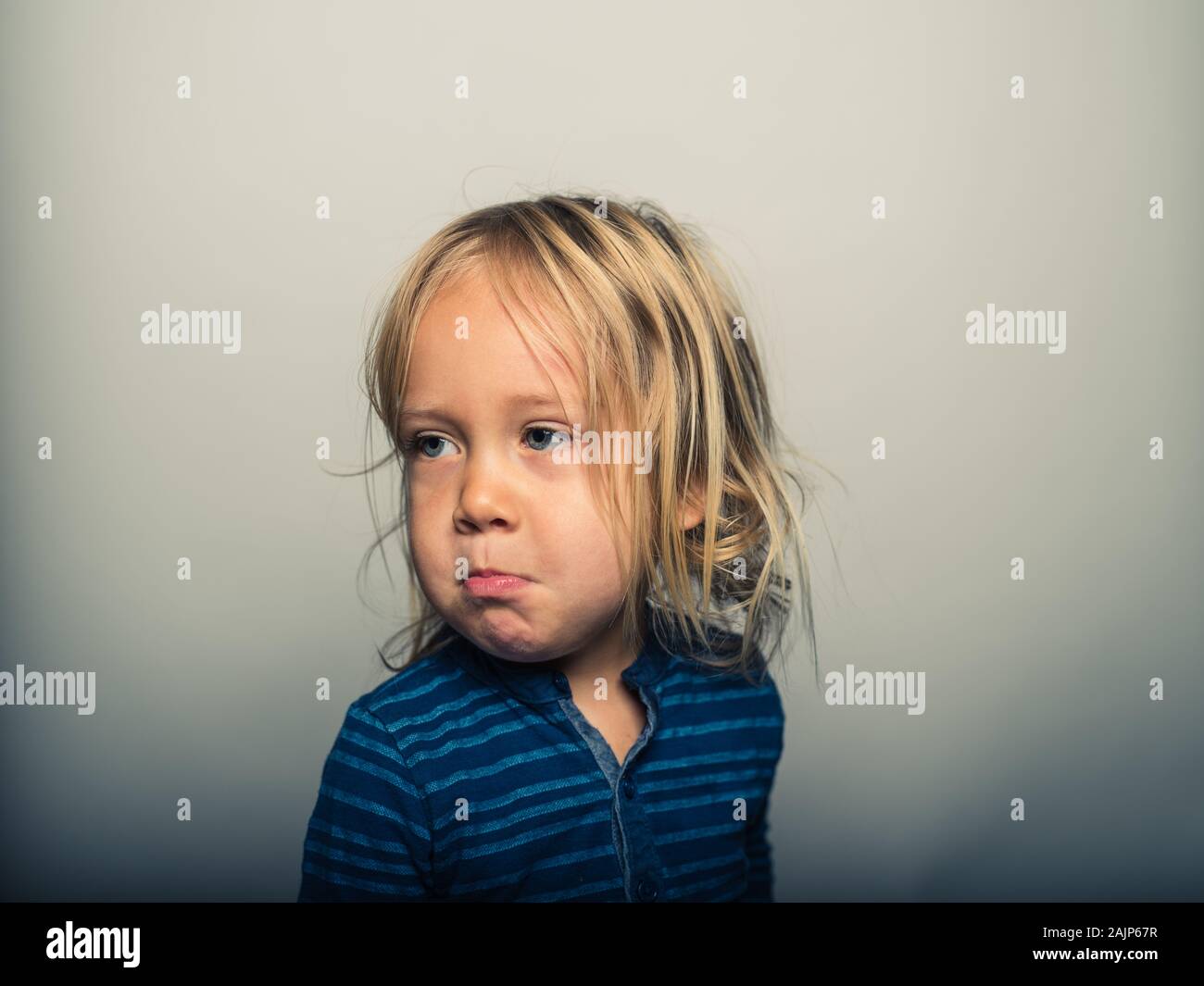 Studio portrait of toddler pulling faces Stock Photo - Alamy