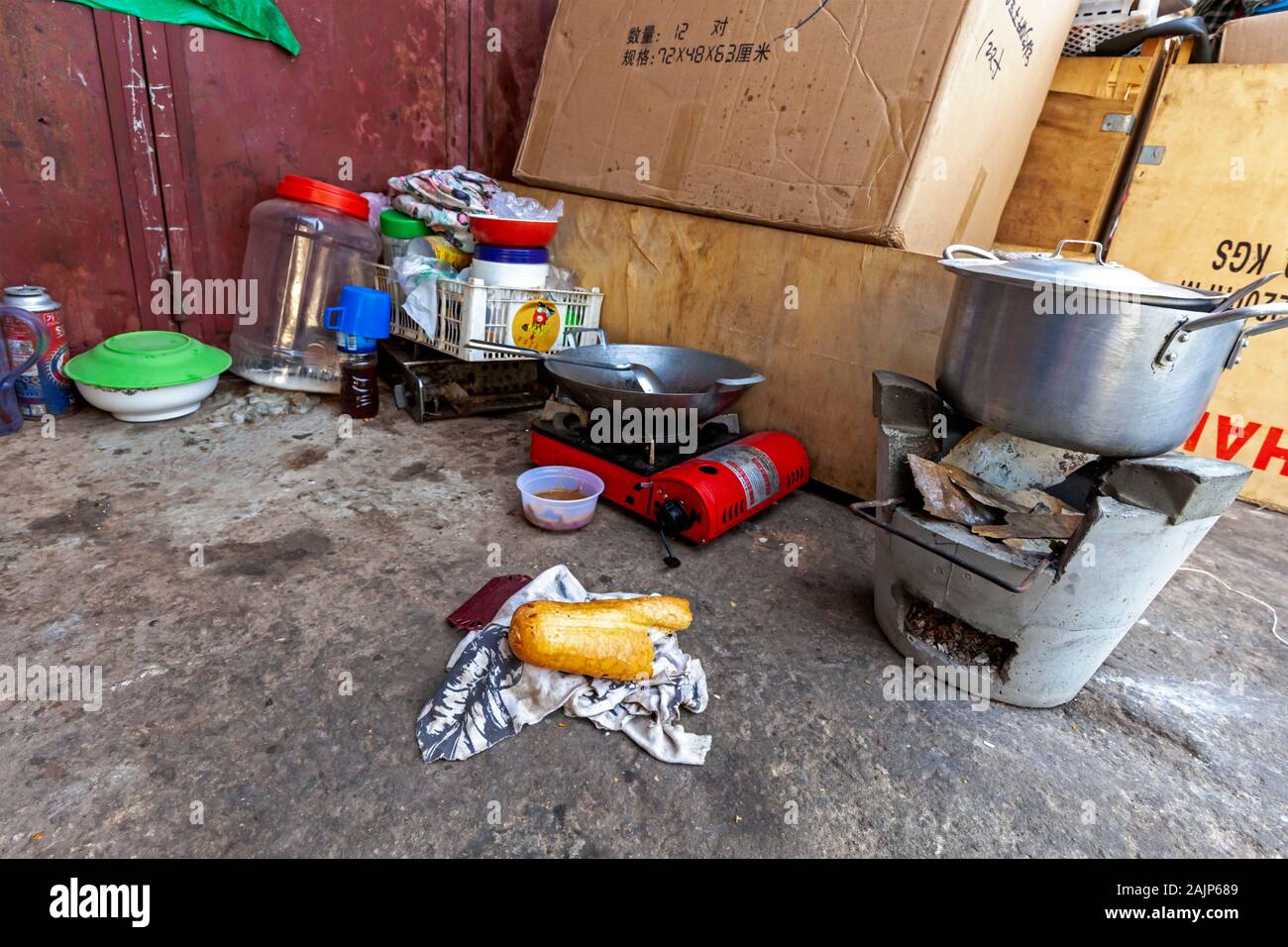 Large cardboard boxes serve as a windbreak for a homeless scavenger ...