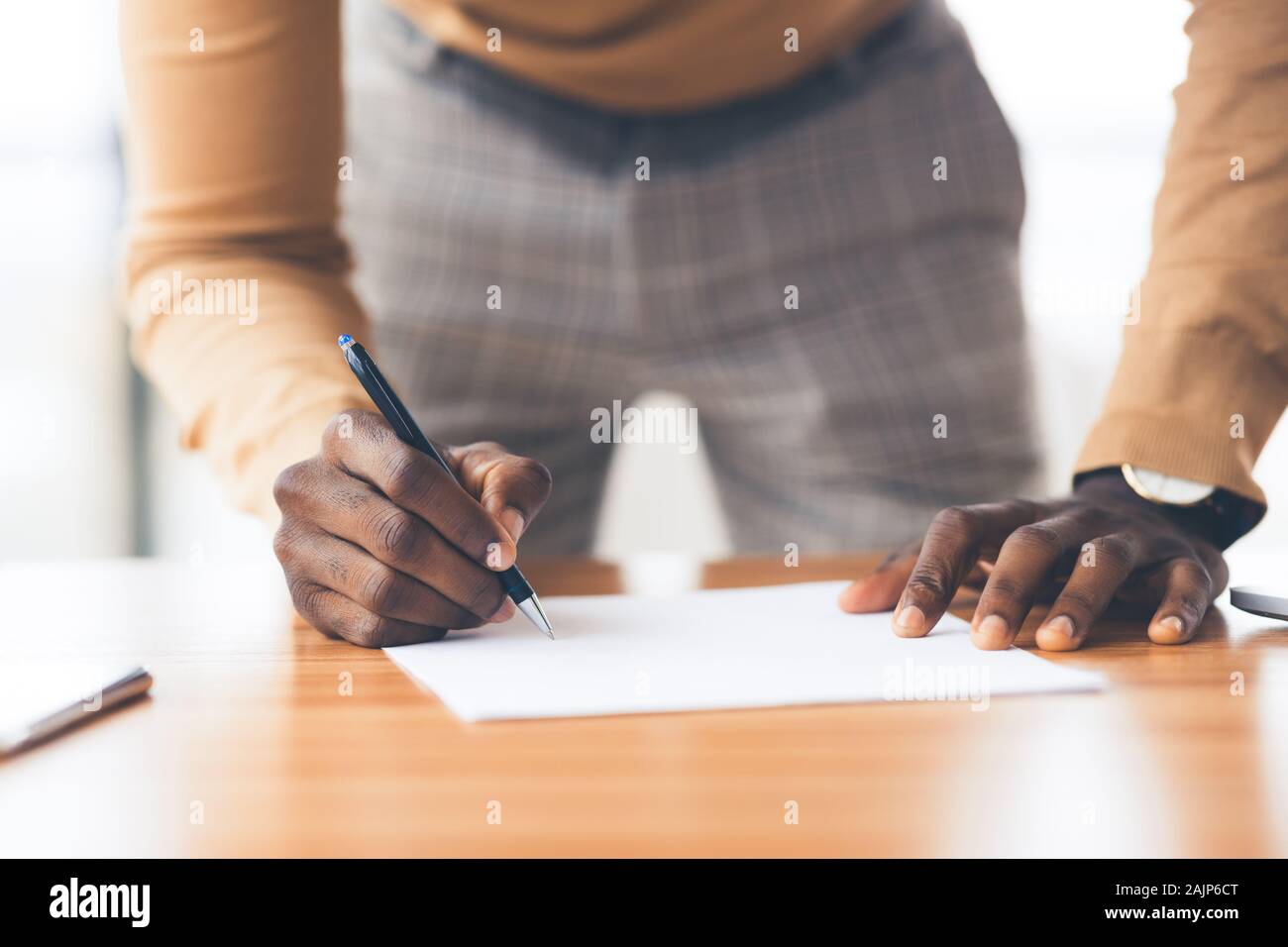 Concluding Contract. Unrecognizable black businessman signing document ...