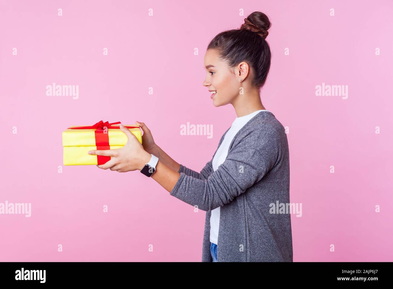 Share present. Side view portrait of generous teenage brunette girl ...