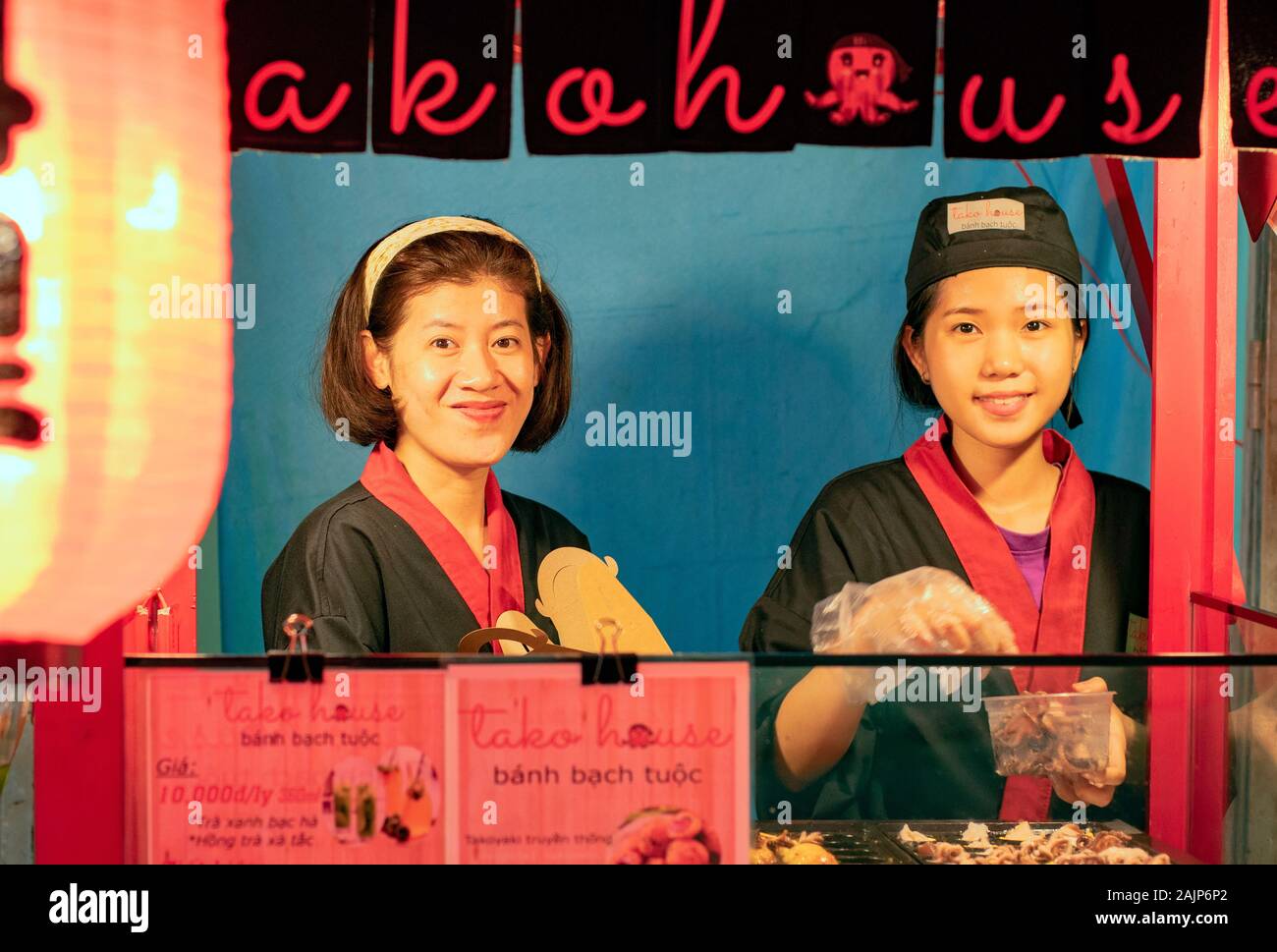 Two asian girls make food on the street Stock Photo - Alamy