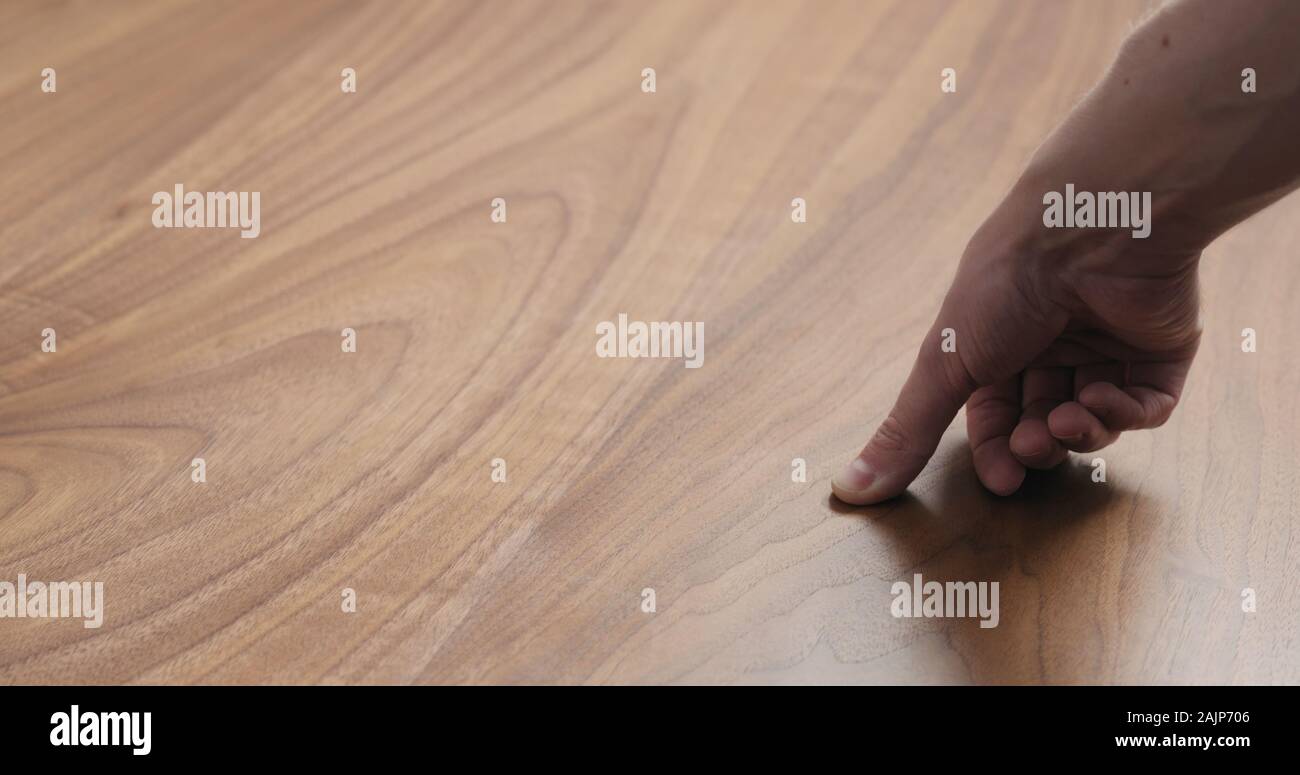 man hand touches black walnut dining table surface, wide photo Stock ...