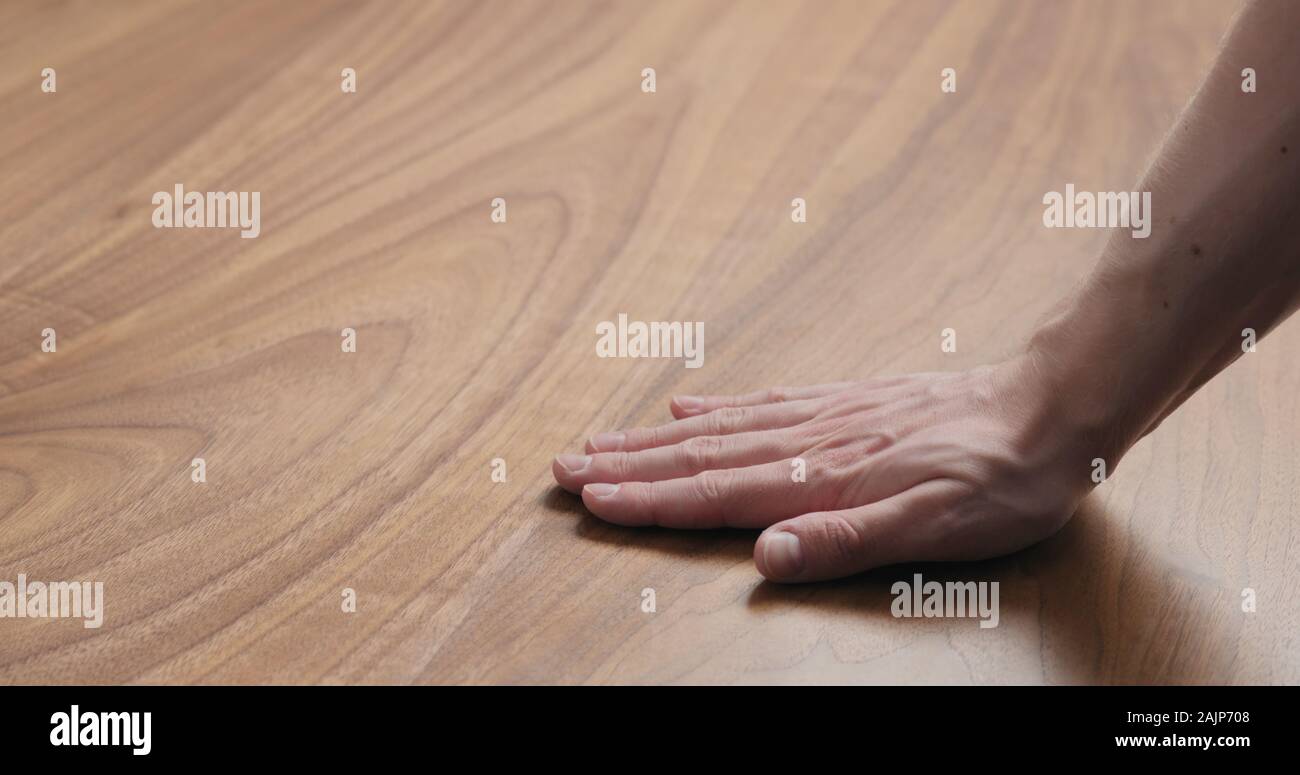 man hand touches black walnut dining table surface, wide photo Stock ...