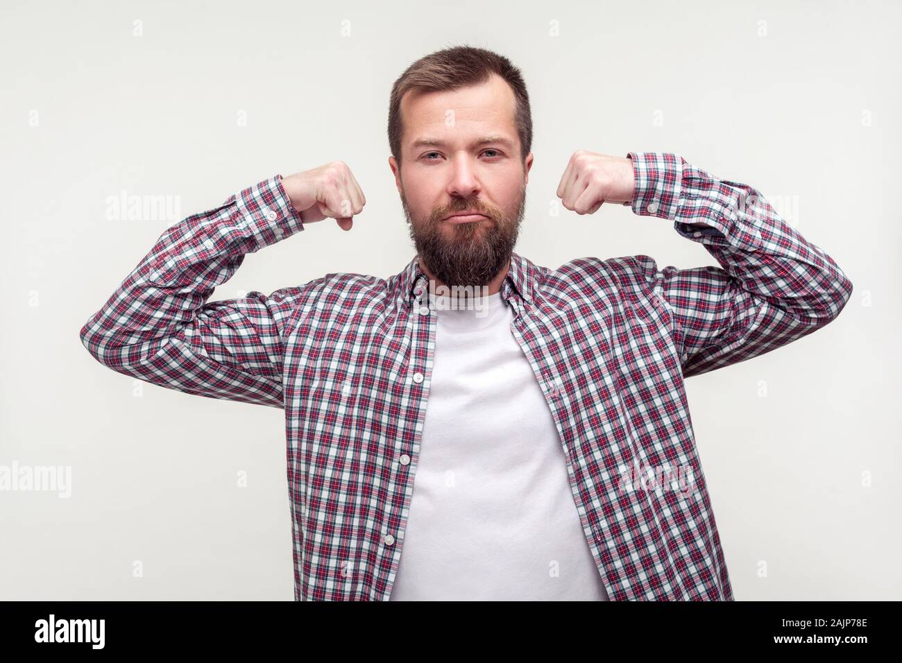 Look at my strength. Portrait of proud bearded man in casual plaid ...