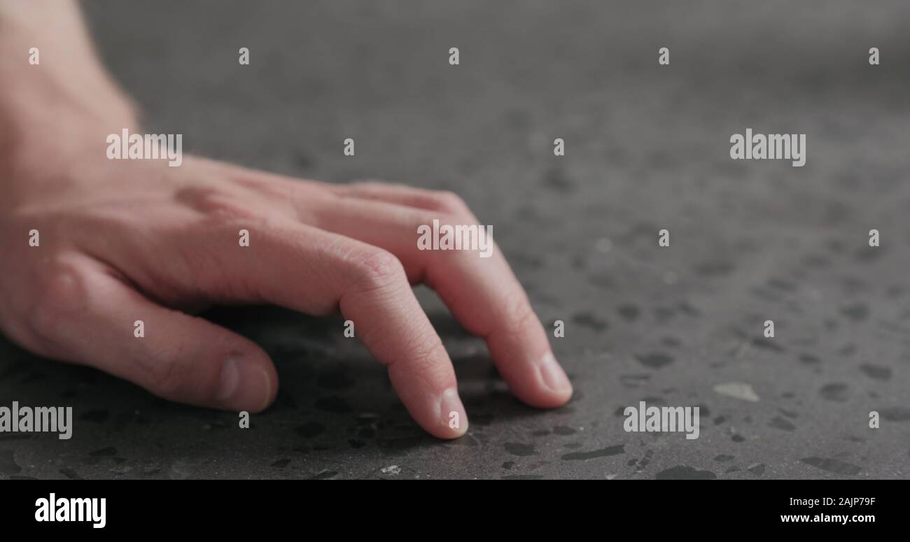closeup man finger tapping on terrazzo countertop, wide photo Stock ...