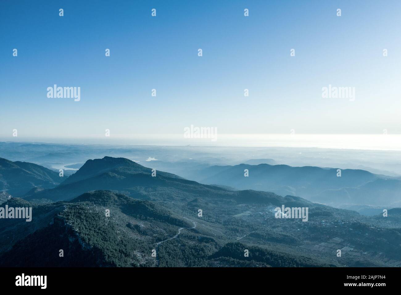 An aerial view of the forest and mountains with an open sky Stock Photo ...