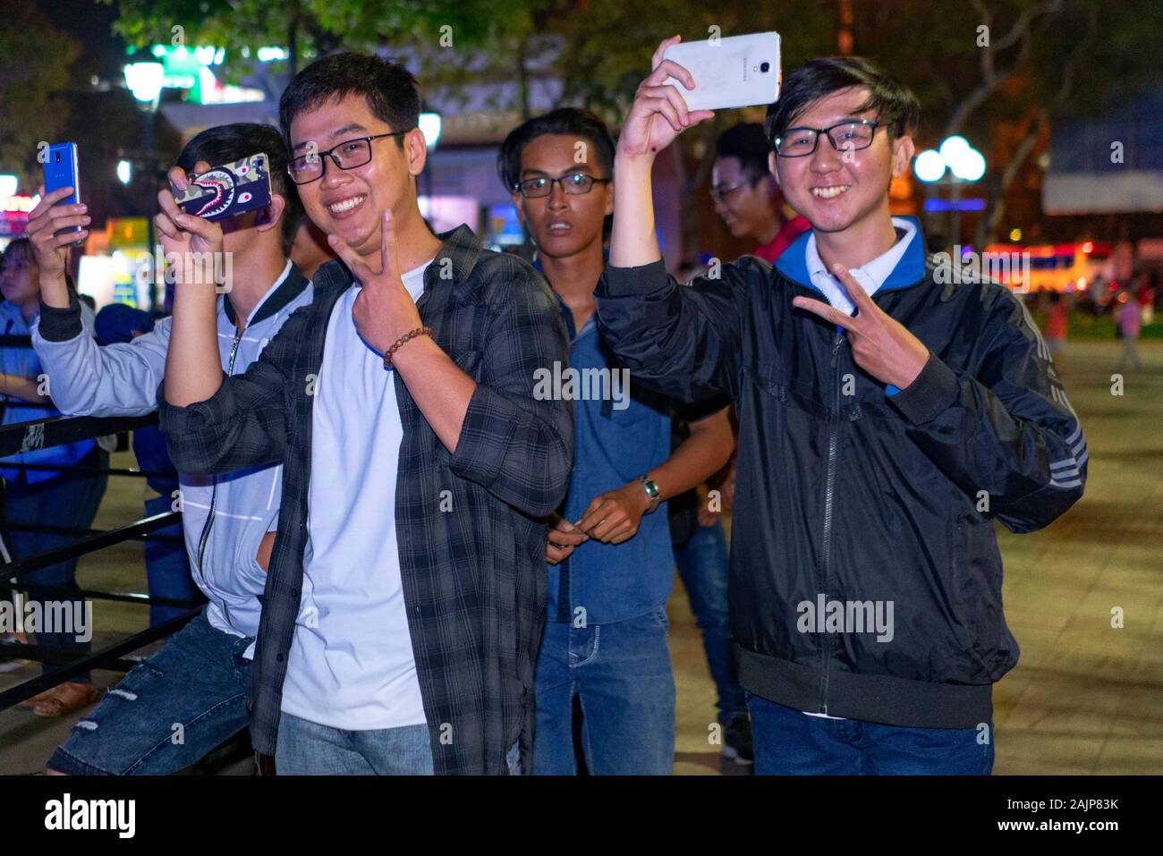 Asian teenagers filming with their smartphones Stock Photo - Alamy