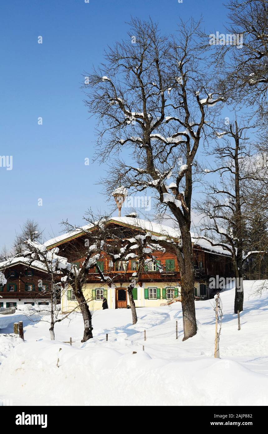 Austria, Tyrol, farmstead in traditional architecture covered with snow ...