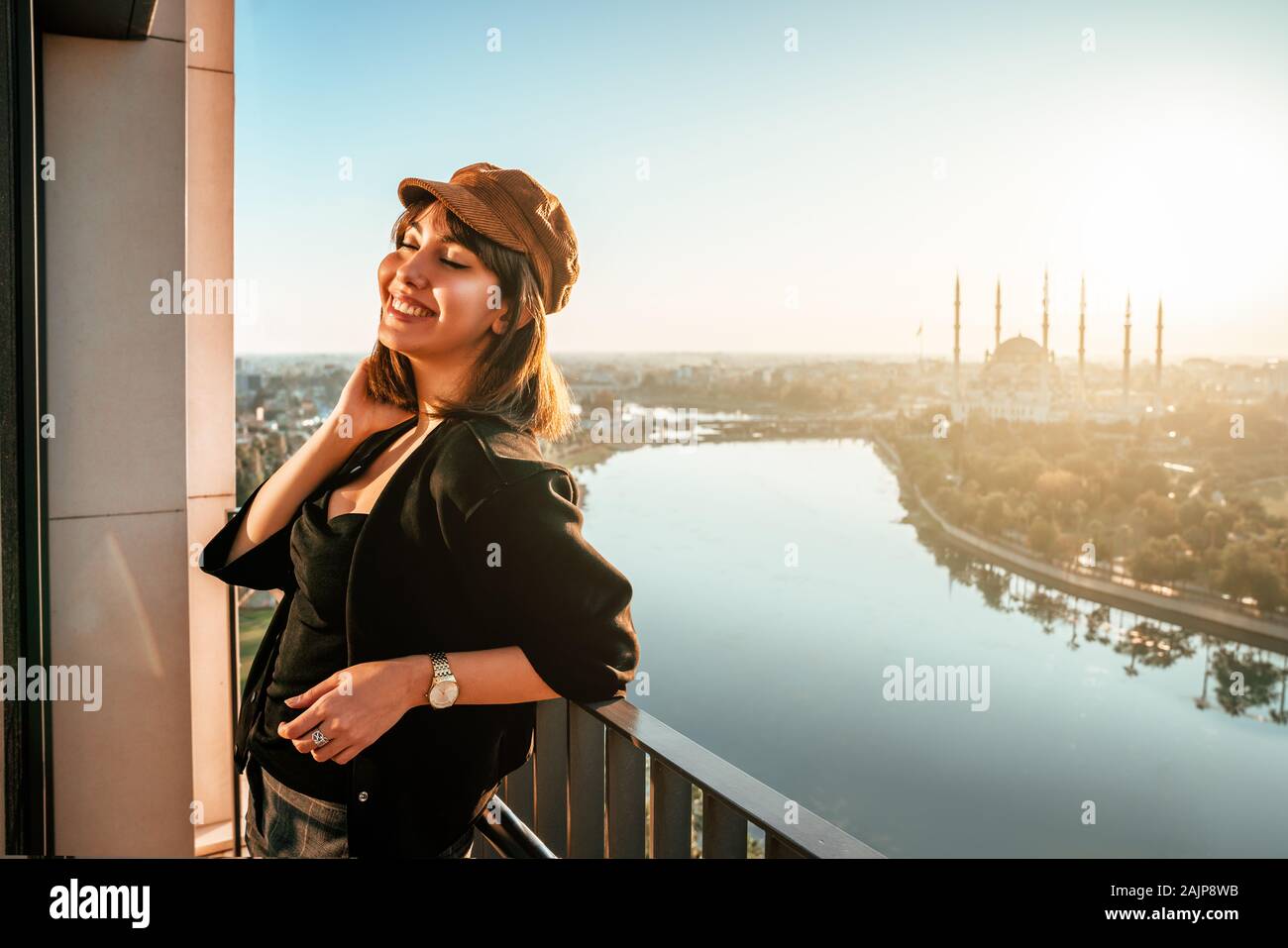 Woman looking down from balcony hi-res stock photography and images - Alamy