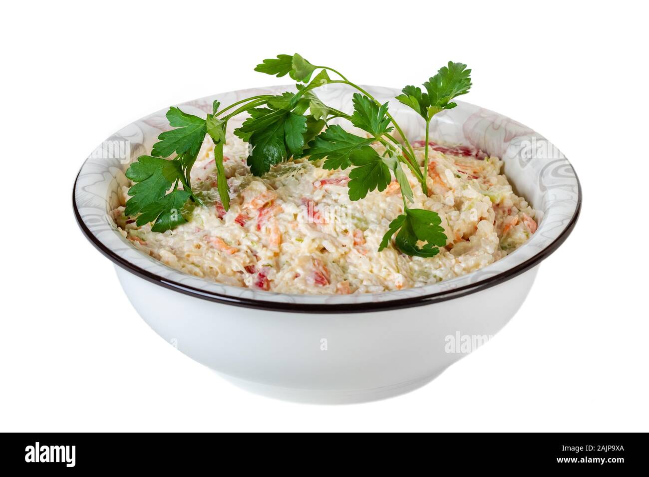 salad of rice, vegetables with mayonnaise in a bowl on a white ...