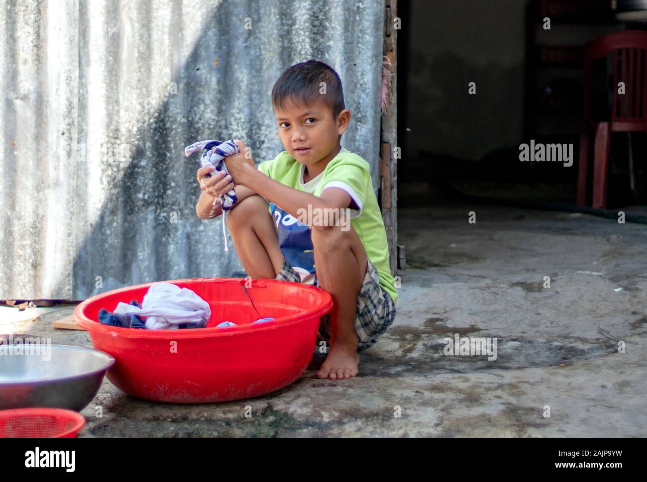 Boy washing clothes hi-res stock photography and images - Alamy