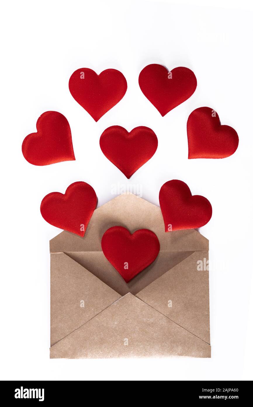 Valentine day love letter, envelope of craft paper with red hearts heap ...