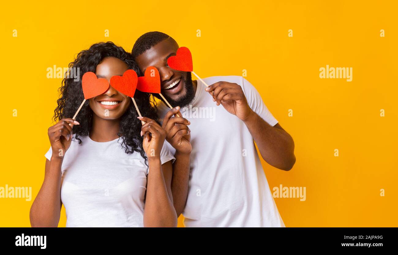 Lovers blinded by their big love.. Young cheerful african-american ...