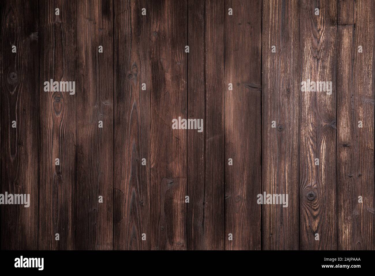 Dark brown wooden tiles floor texture background with dramatic light ...