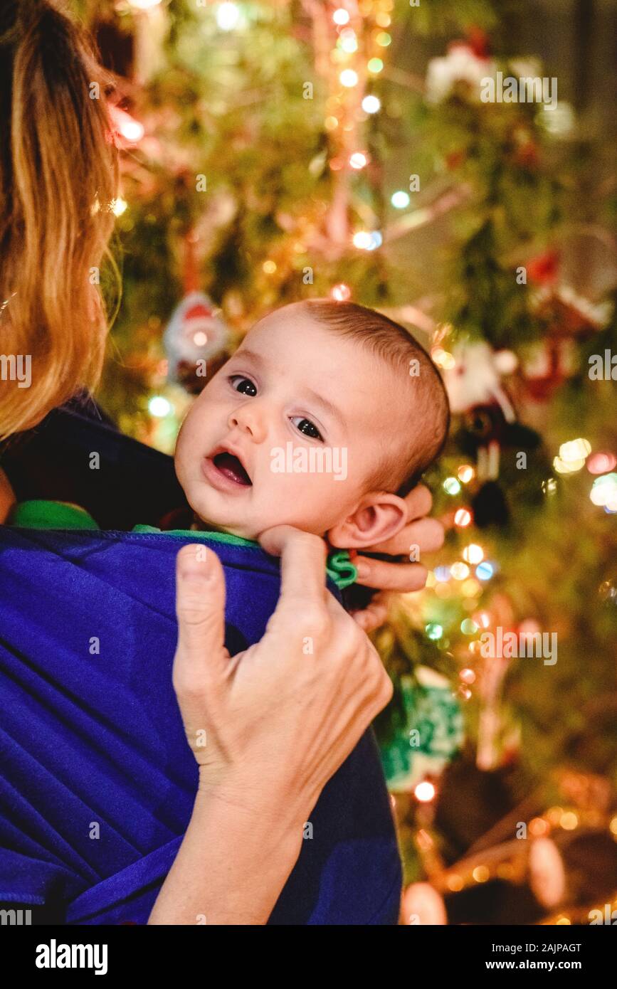 Newborn baby portaged by his mother in a traditional scarf Stock Photo ...