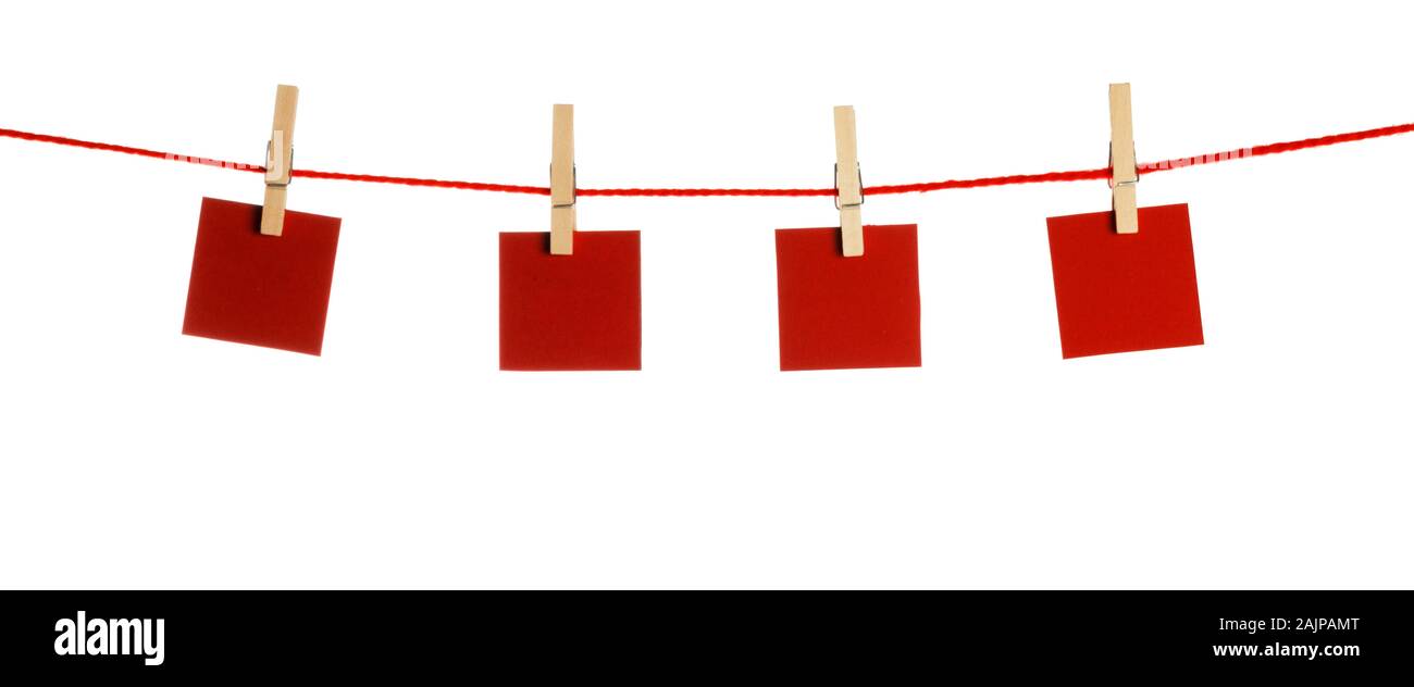 Set of four red blank paper notes held on a string with clothespins ...