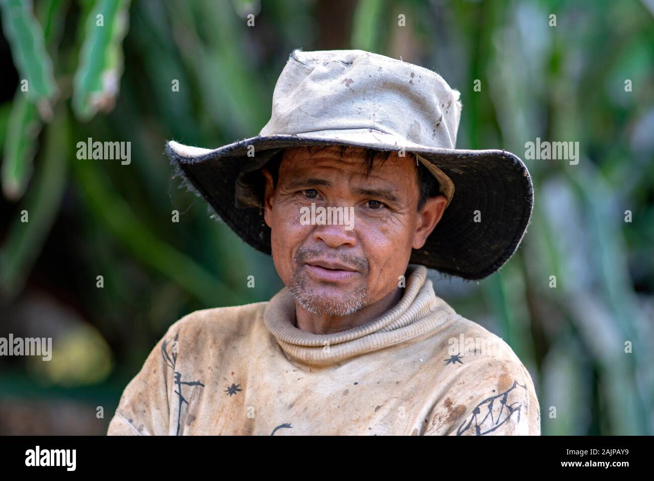 Portrait of a bahnar tribe man wearing a hat Stock Photo - Alamy