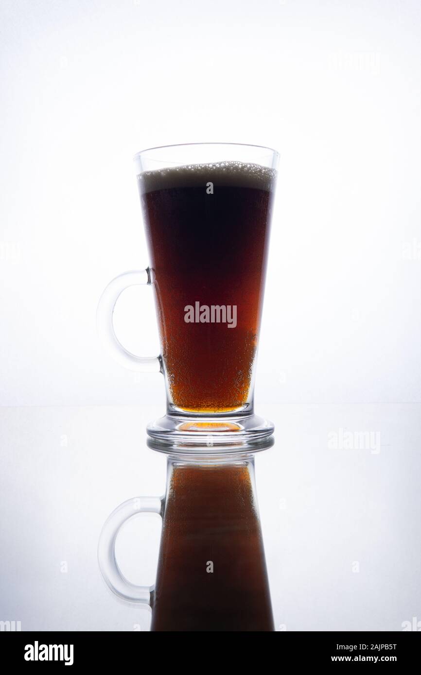 Dark beer in a mug on a white background with reflection Stock Photo ...