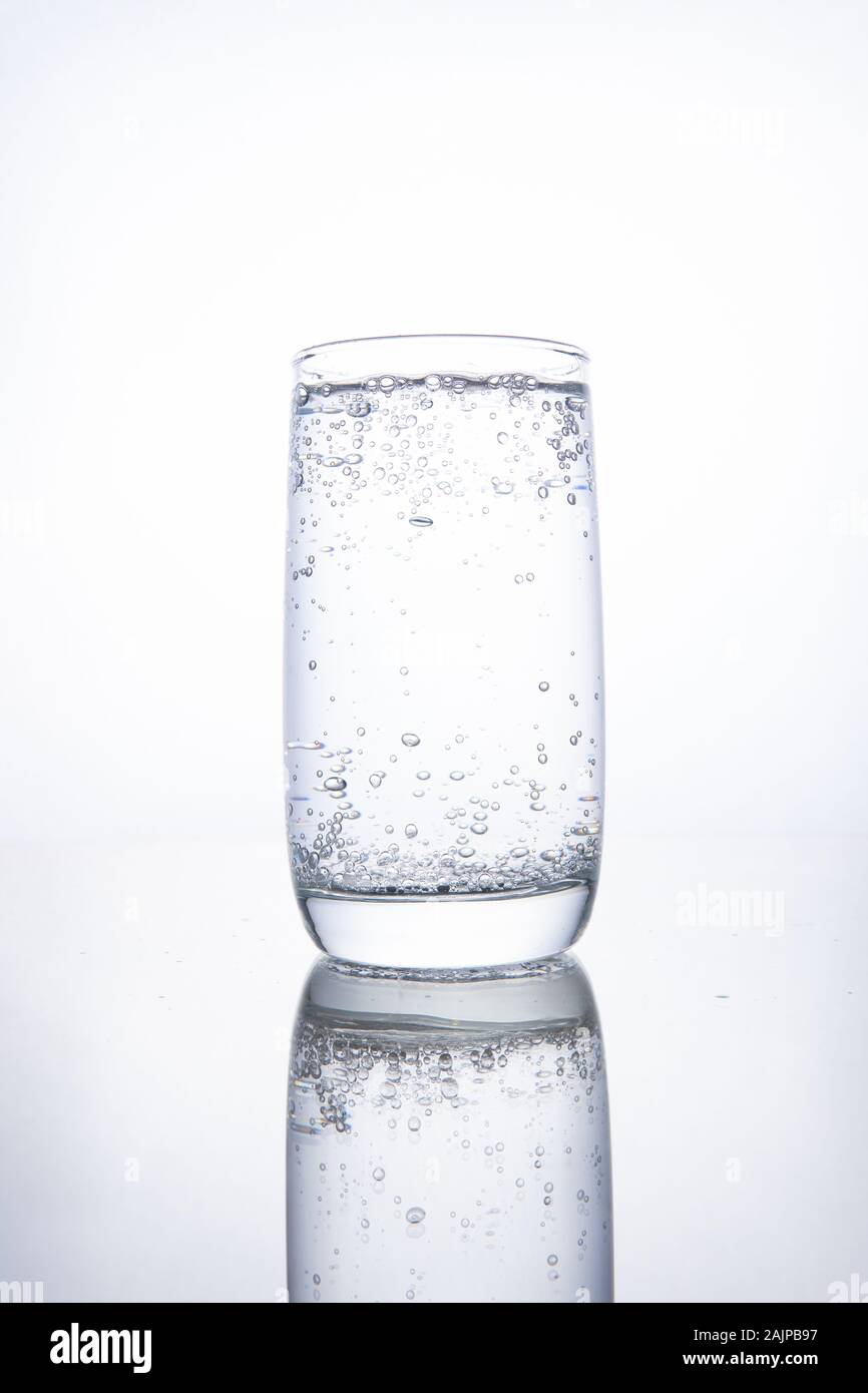 Full glass cup with carbonated pure mineral water Stock Photo - Alamy