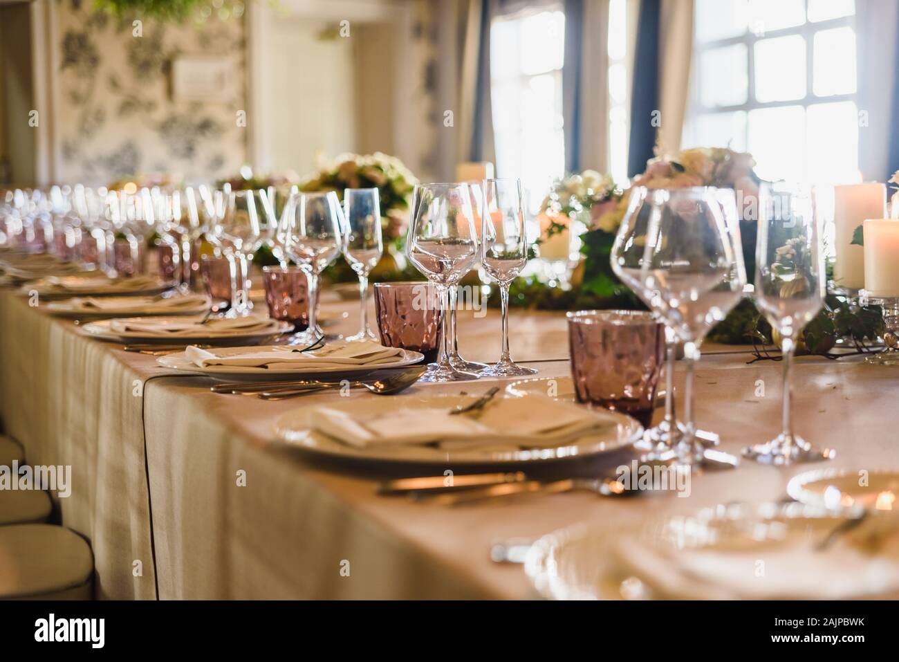 Elongated table with all the cutlery elegantly arranged and beautiful ...