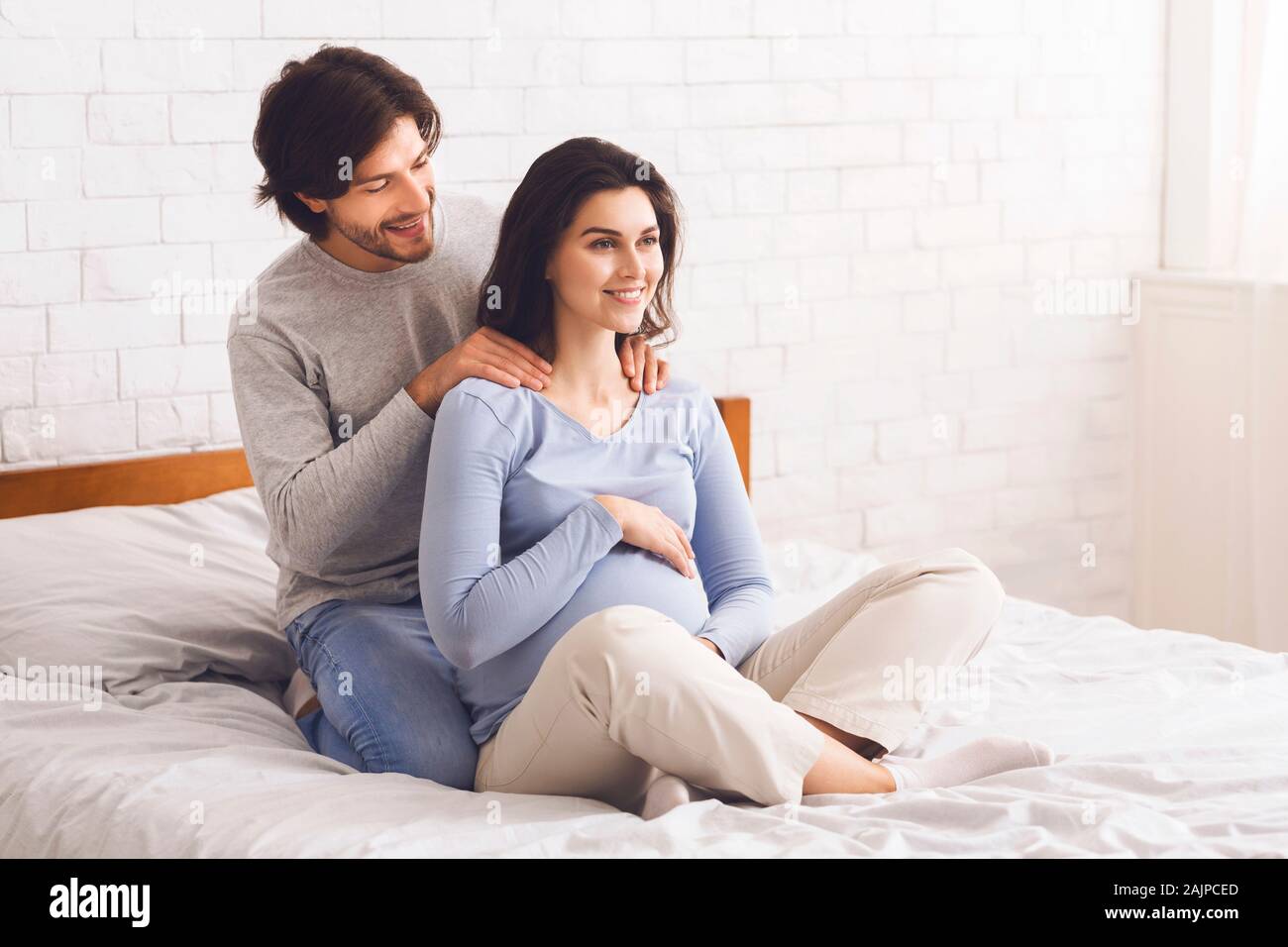 Prenatal Massage Concept Caring Husband Massaging Neck Of His Pregnant