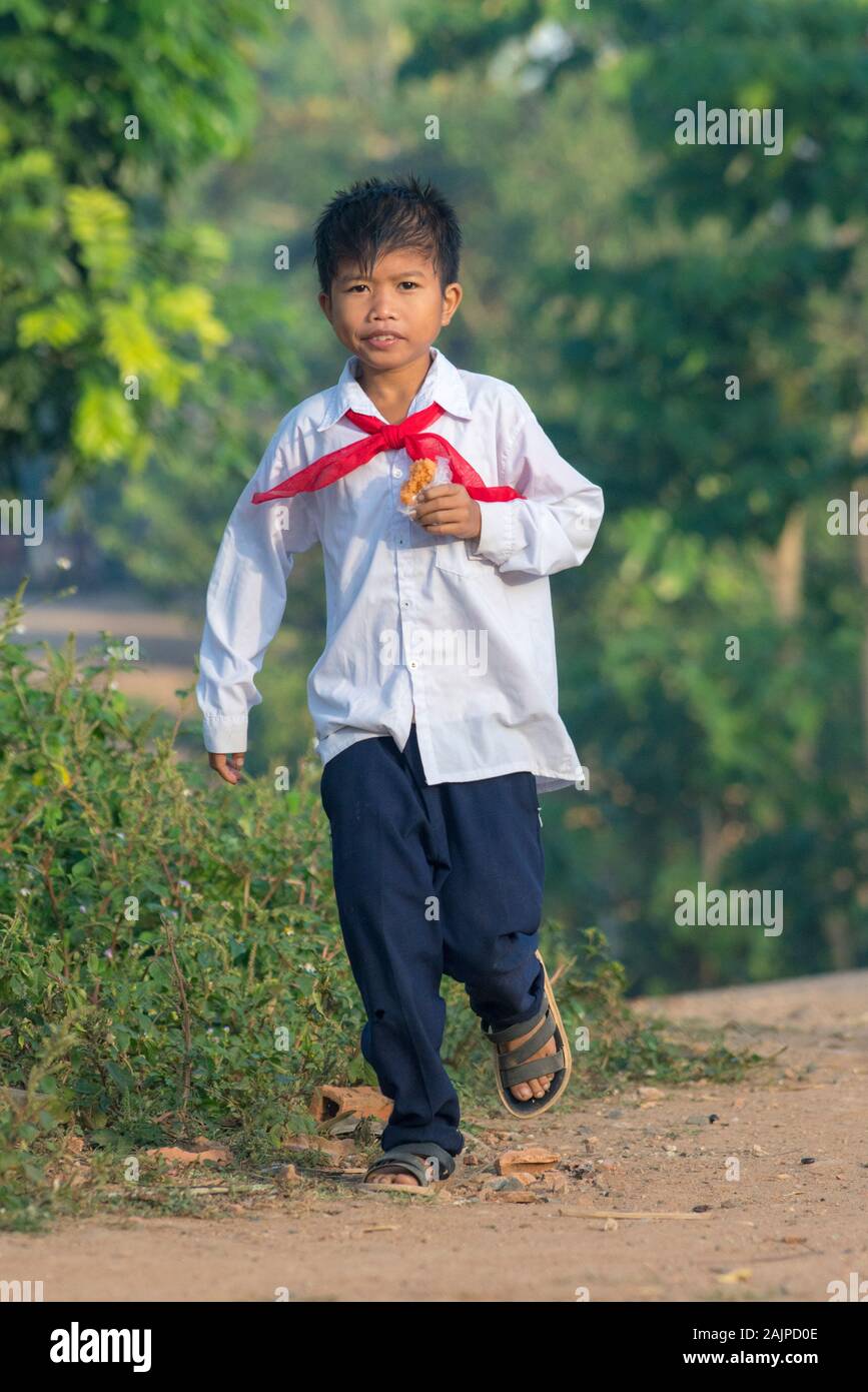 A child in school uniform runs Stock Photo - Alamy