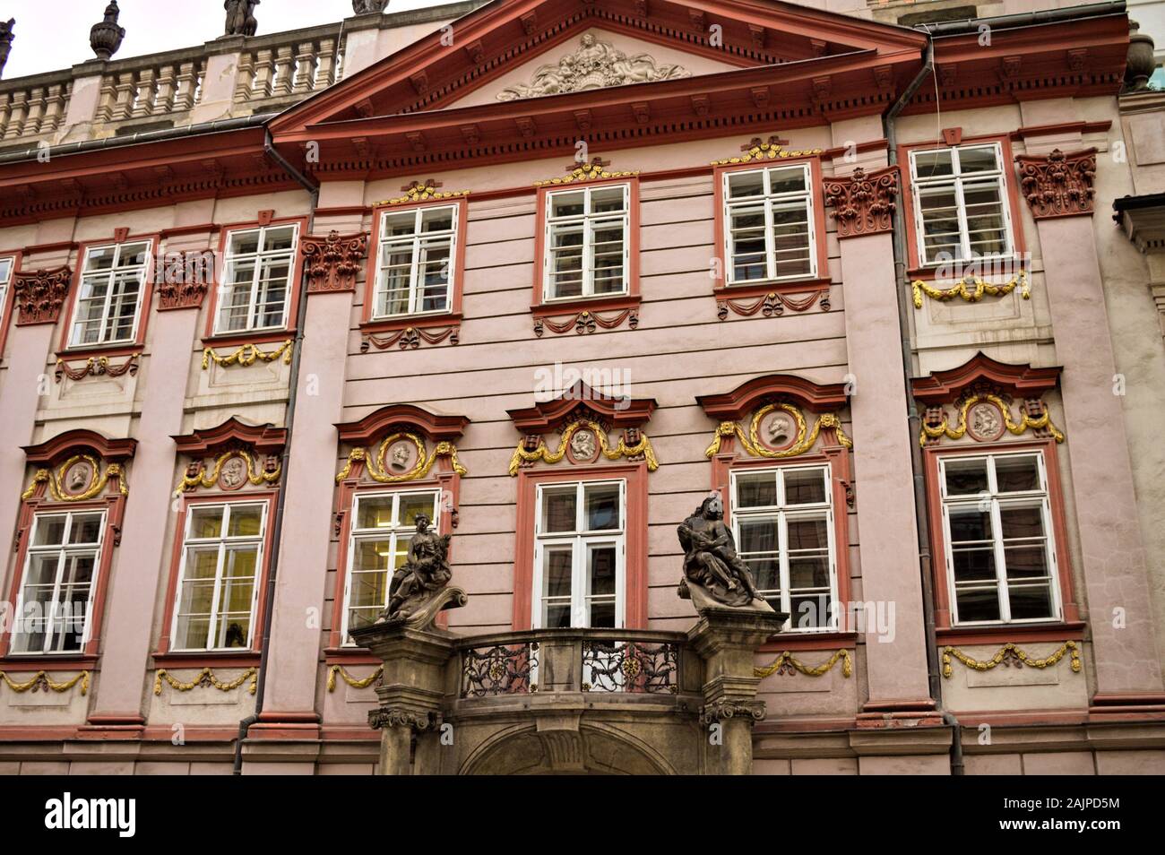 Old pink bohemian building with columns and red decorations (Prague ...