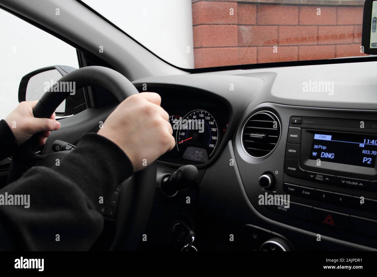 a modern dashboard in a car with a driver behind the wheel Stock Photo ...