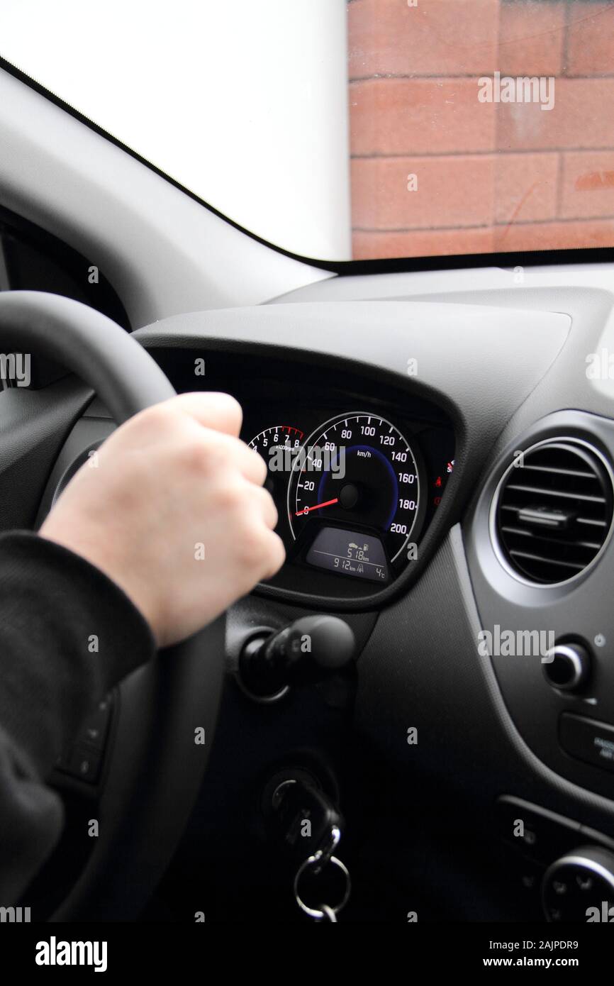 a modern dashboard in a car with a driver behind the wheel Stock Photo ...