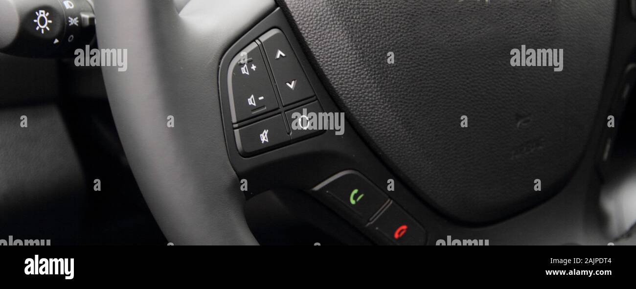 a multifunction steering wheel in a new car Stock Photo - Alamy