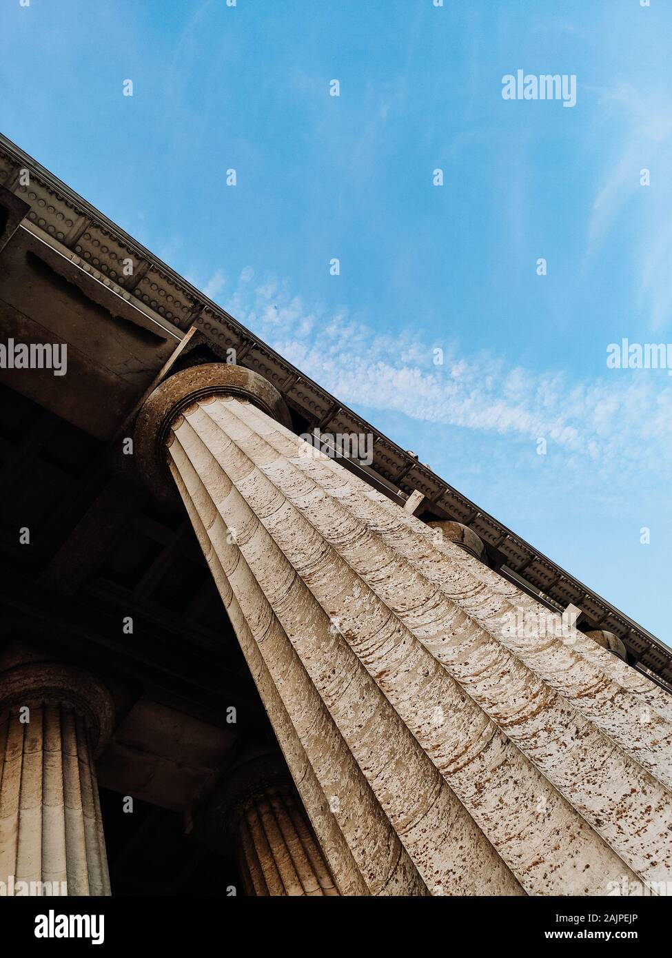 Columns on blue sky background. Vertical photo Stock Photo - Alamy