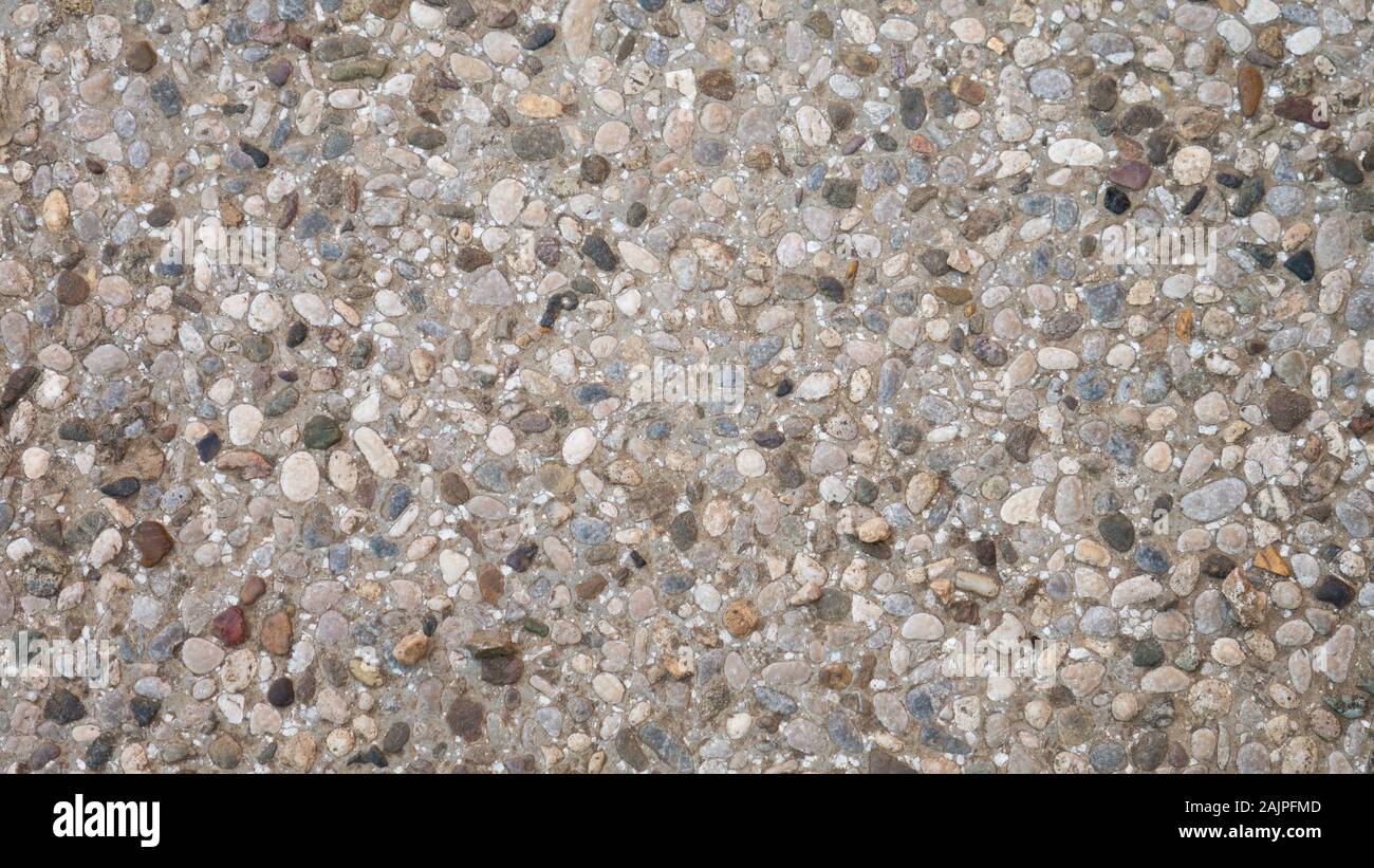 Pebble in concrete path. Top view stone background. Stone paving ...