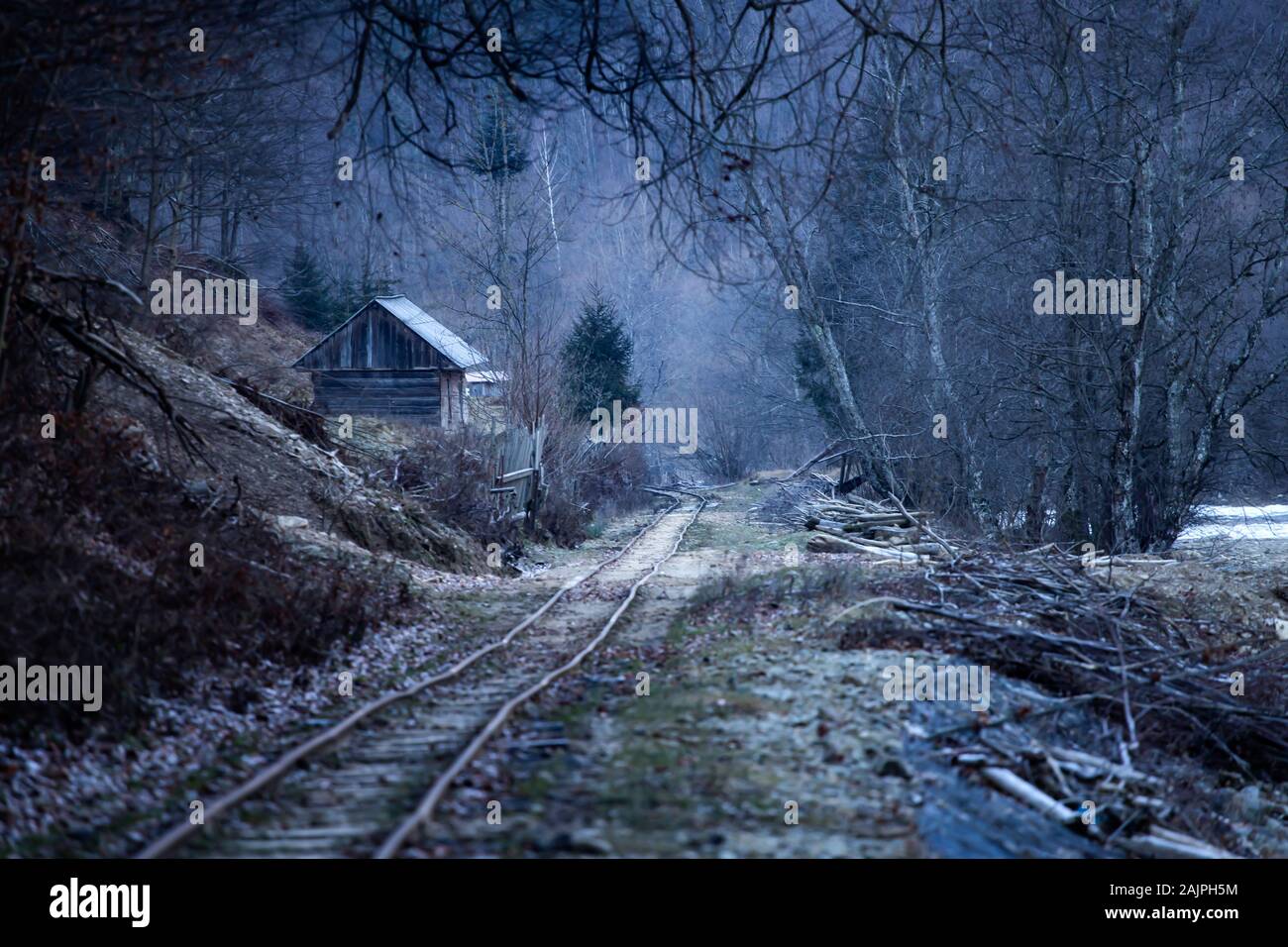 Old wooden cottage near railways in the romanian mountains.Creepy rural ...