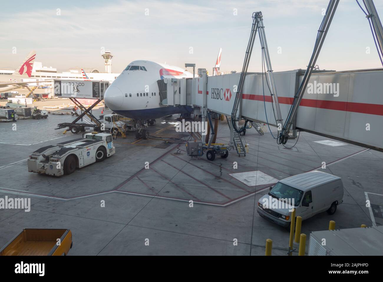 Airplane on tarmac waiting for people to board. The walkway tunnel is ...