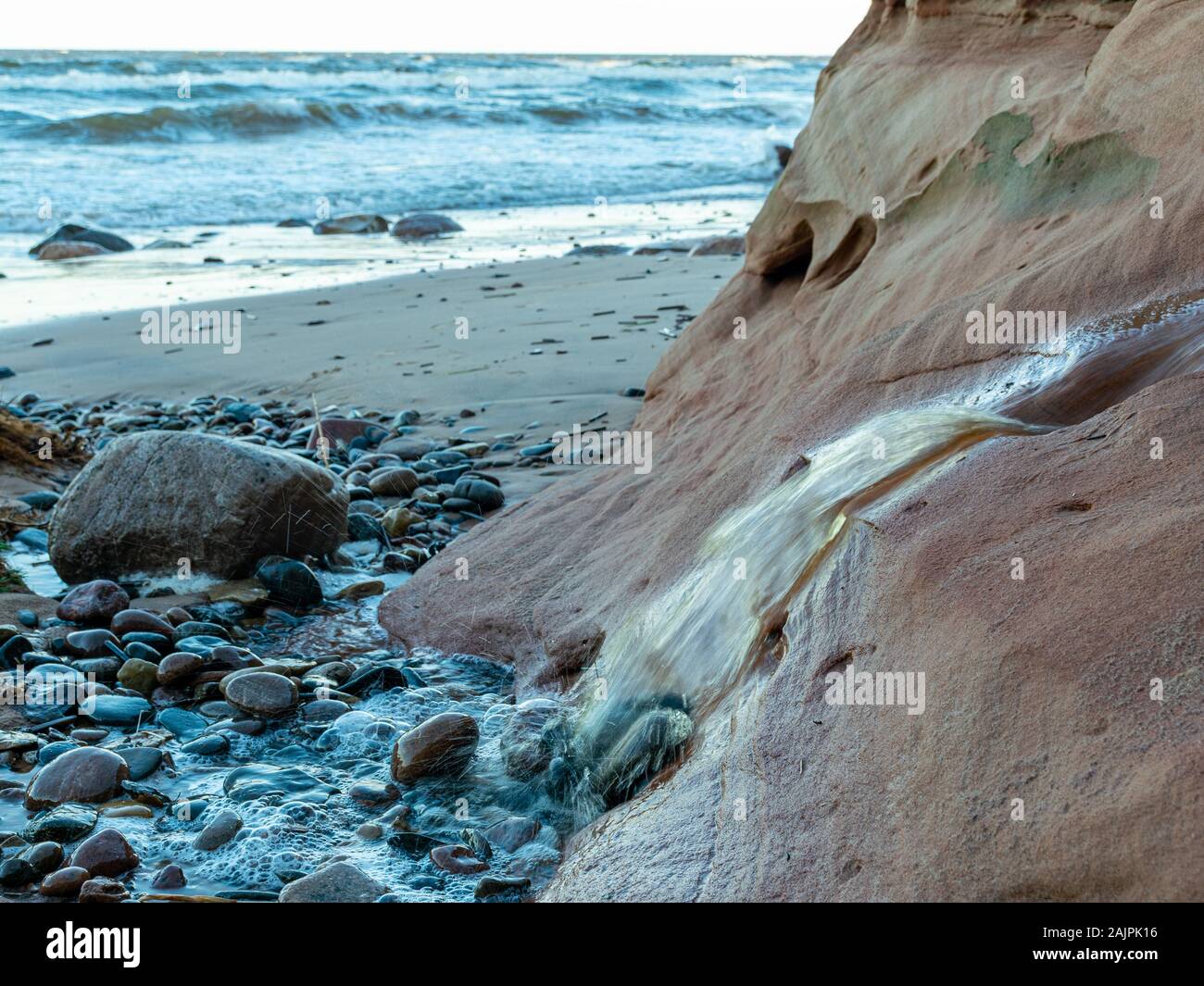 landscape with sandstone cliff at sunrise, rocky seashore, windy ...