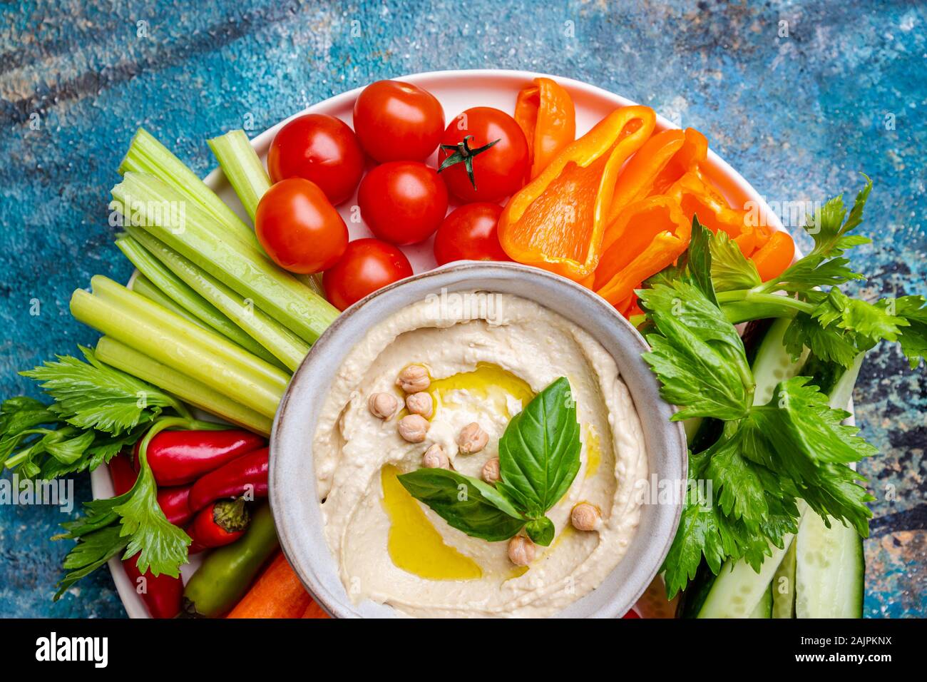 Hummus platter with assorted snacks. Hummus in bowl and vegetables ...