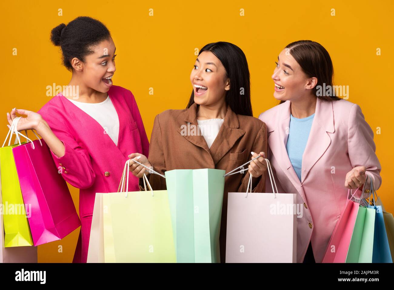 Girls On Shopping. Three Happy Shopaholics Women Holding Shopper Bags ...