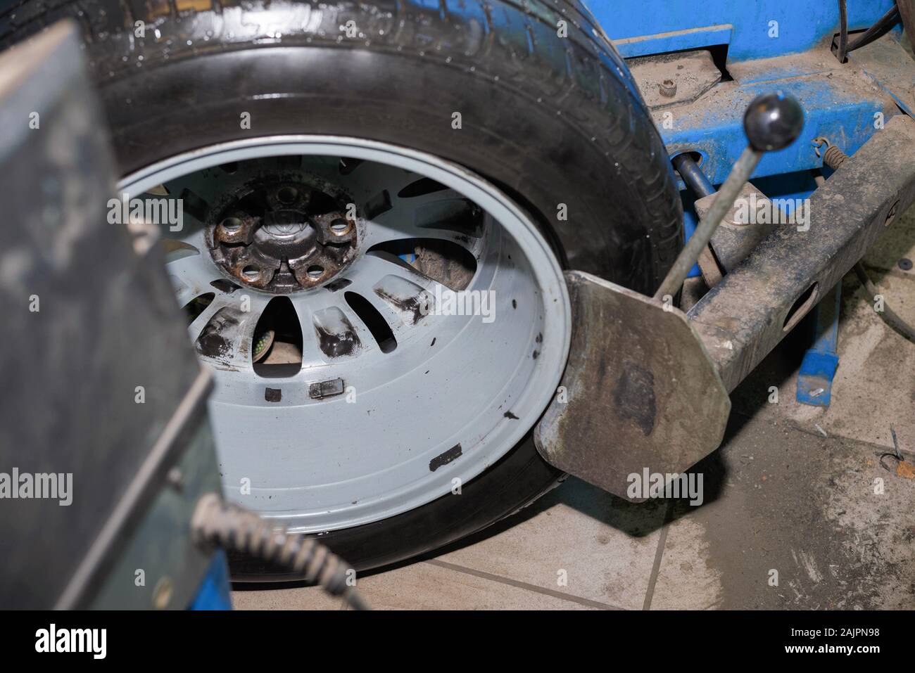 The master removes the tire from the cars drive Replacing a set of ...