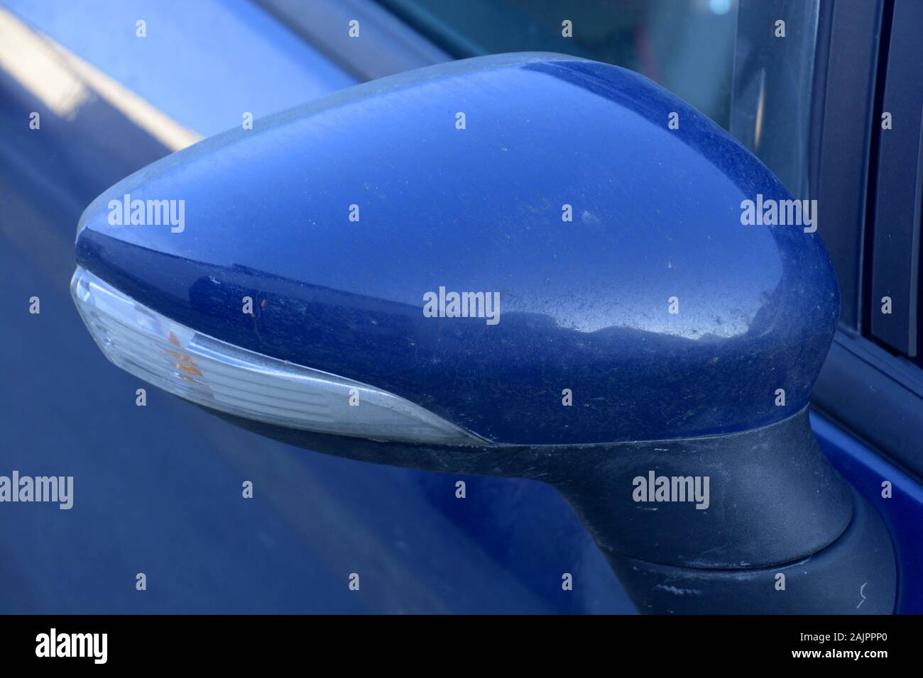 rear-view mirrow backside of a dirty blue colored car with light ...